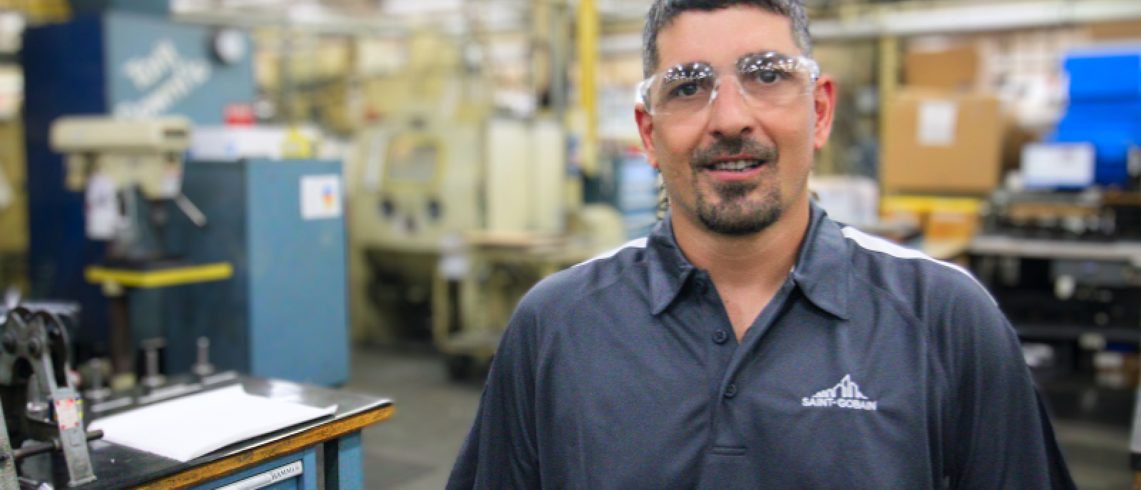 Man in safety glasses at Saint-Gobain North America’s facility ...